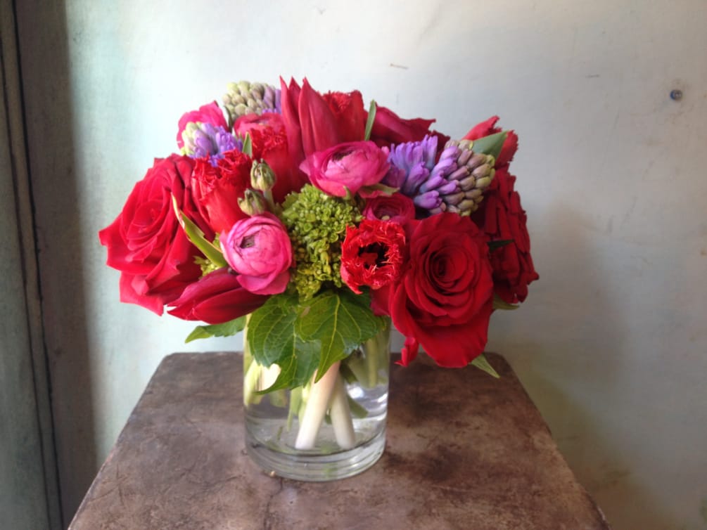 Red Arrangement by Blue Water Flowers