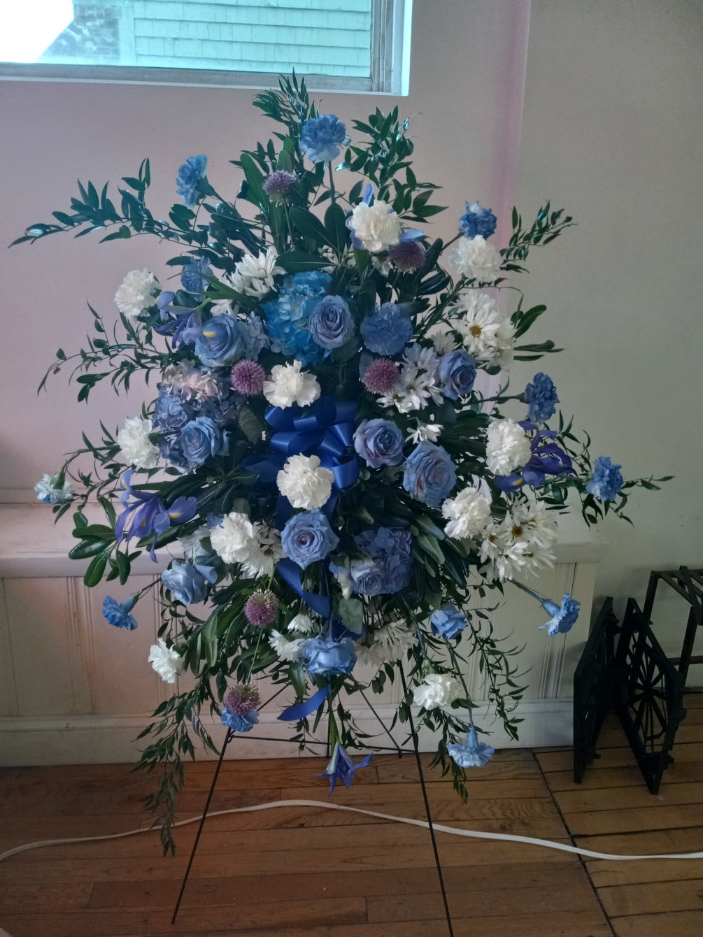 "Blue Lagoon" sympathy standing spray by Elena's Flowers