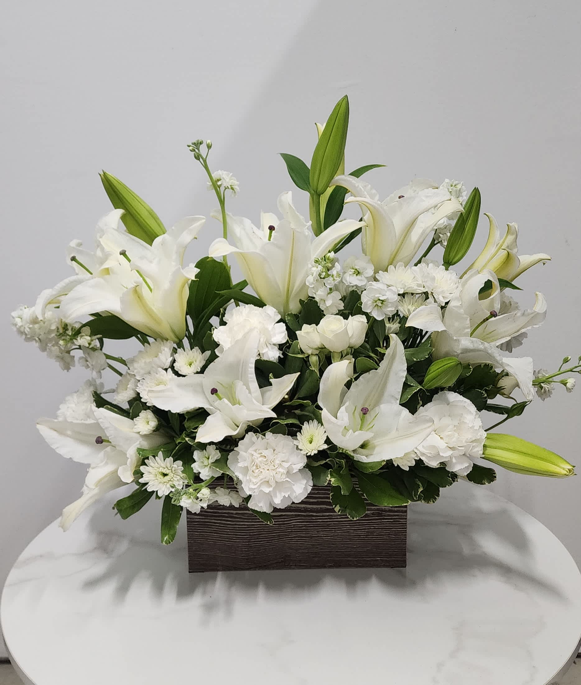 Peaceful White Lilies Basket by Teleflora in MCKINNEY, TX | Big Bud's ...