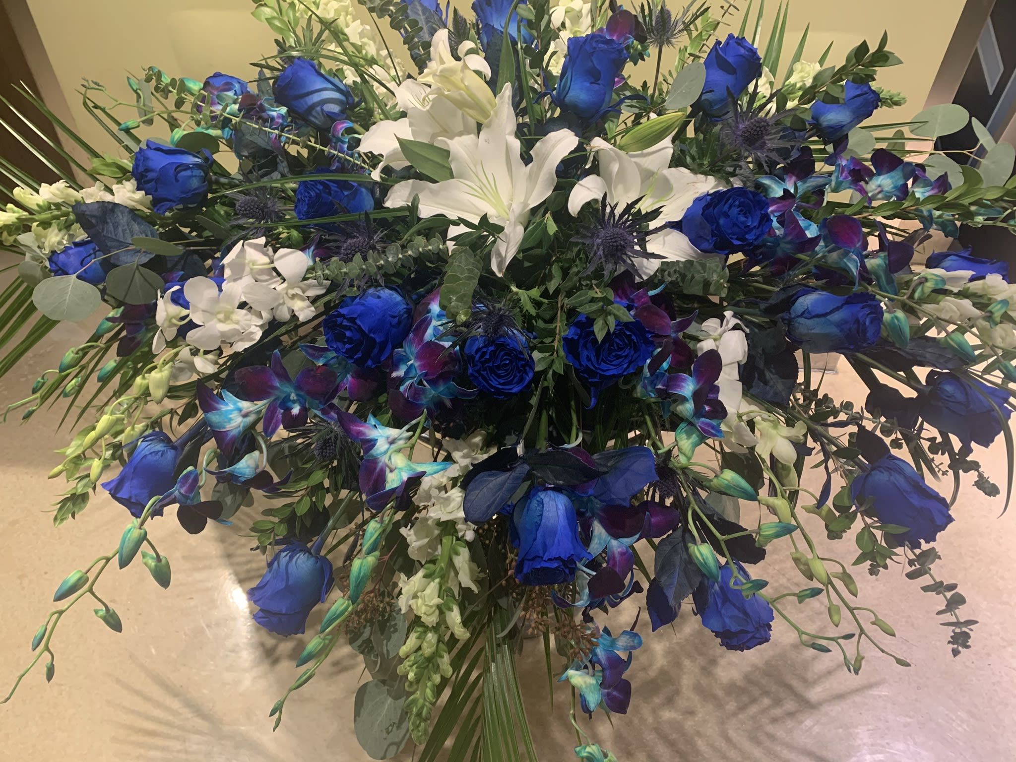 Blue casket piece by Downtown Flowers