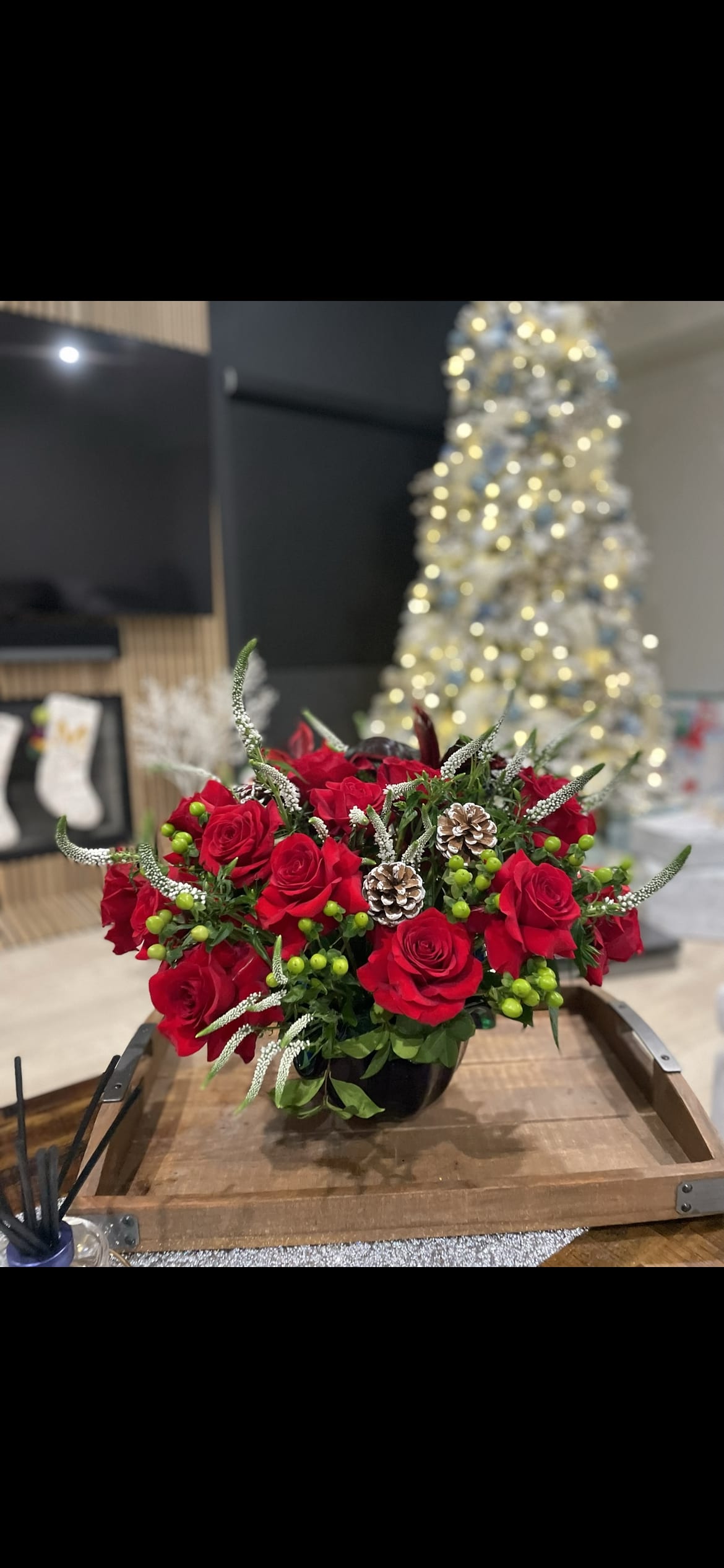 Red roses with pine cones by Vespera Floral Studio